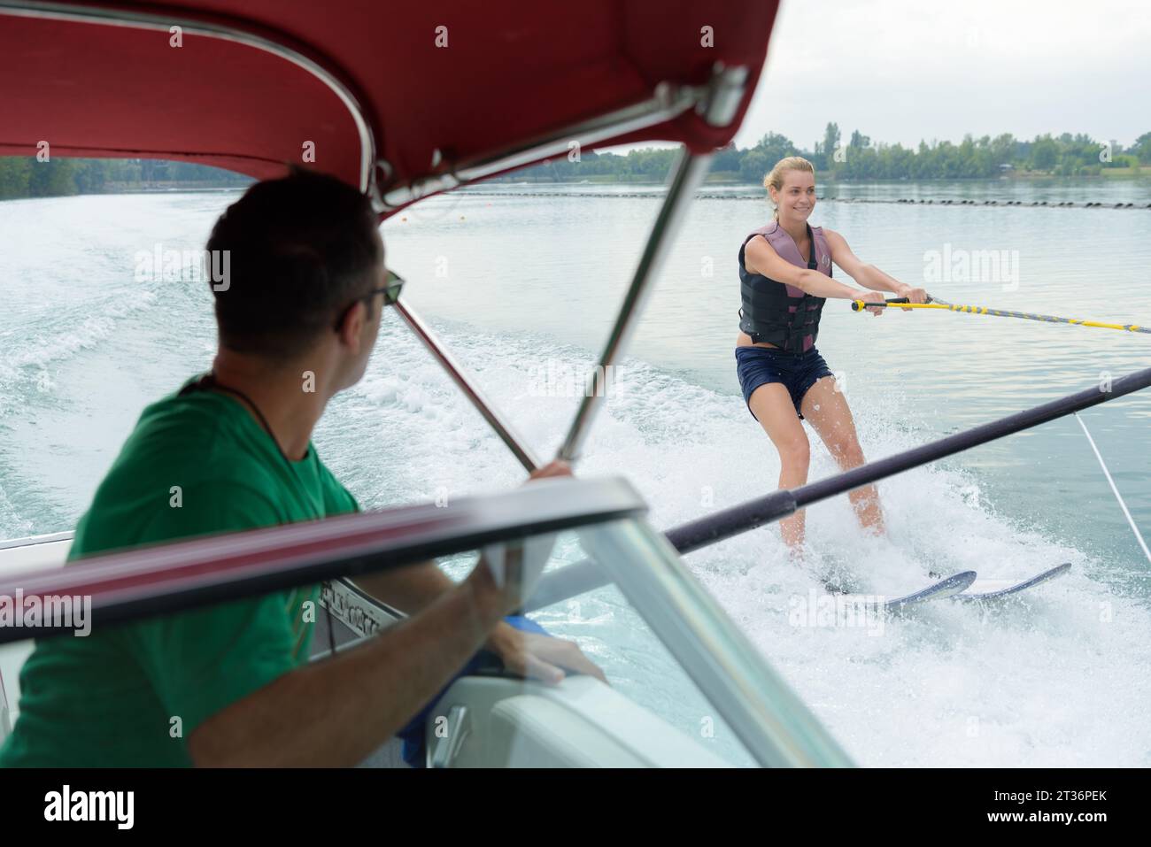 woman training on waterskis along a boat Stock Photo - Alamy