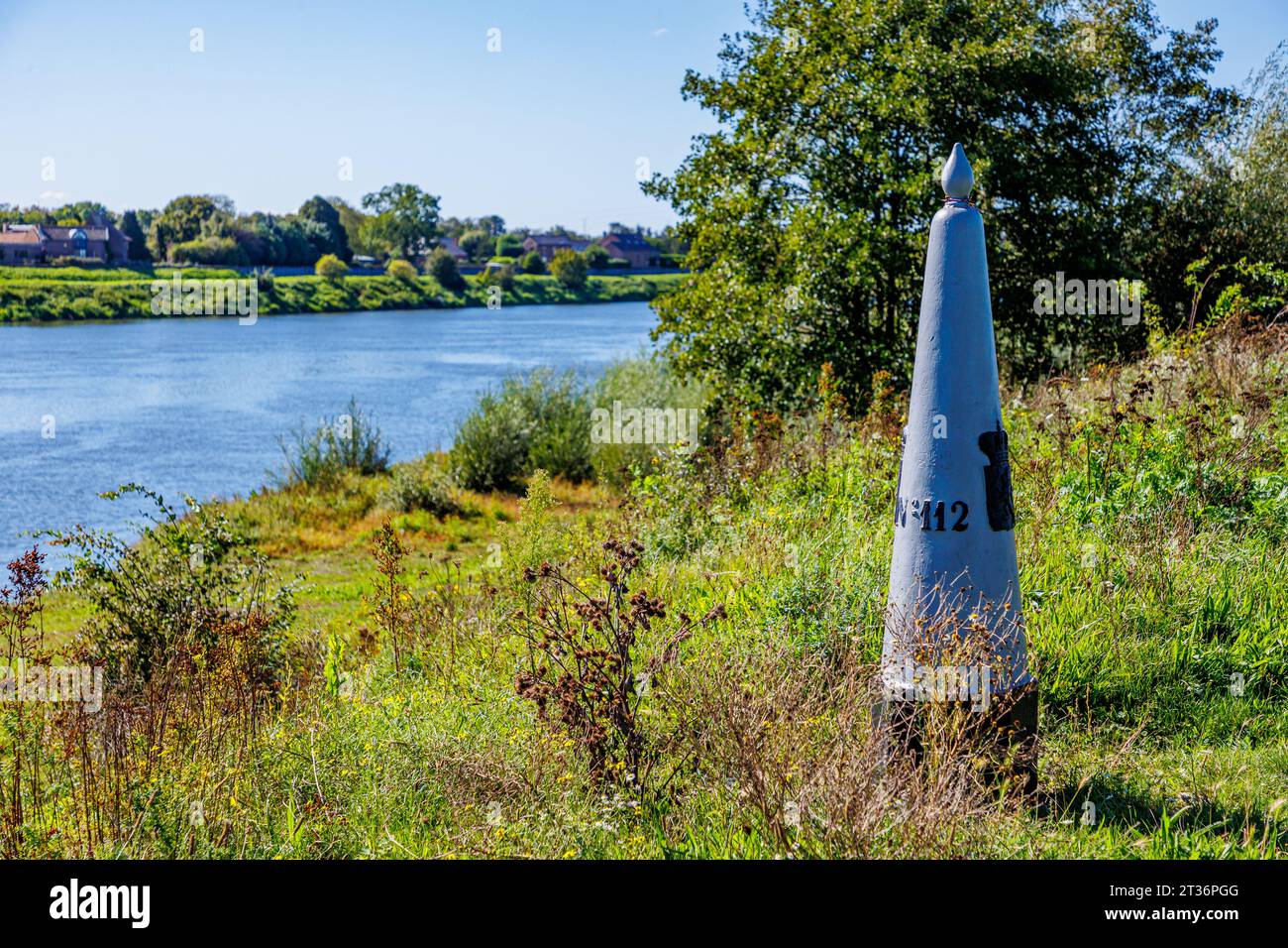 Belgium-Dutch border marker number 112, Maas river, trees and Belgian ...