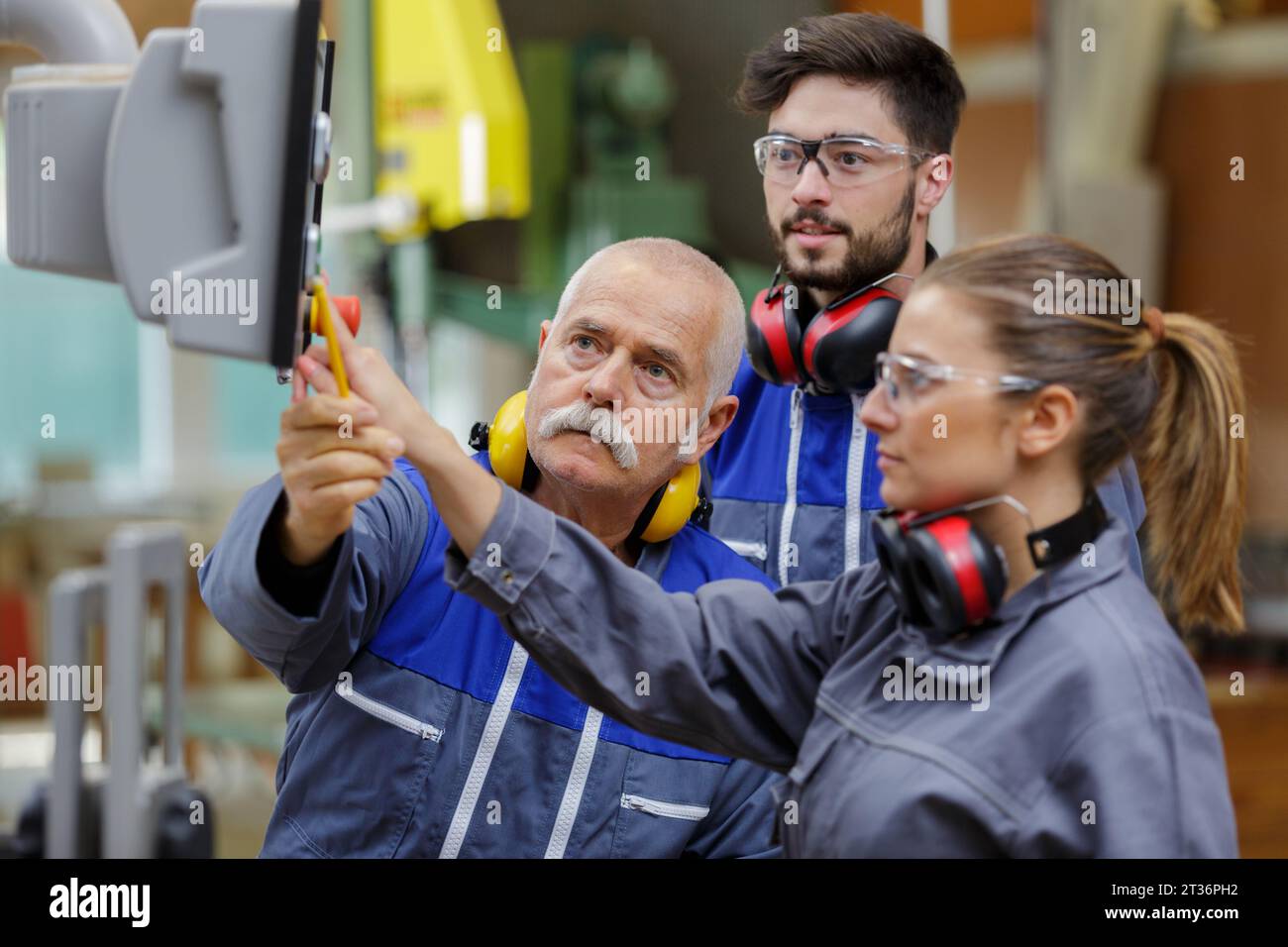 apprentices being shown computer control panel in factory Stock Photo ...