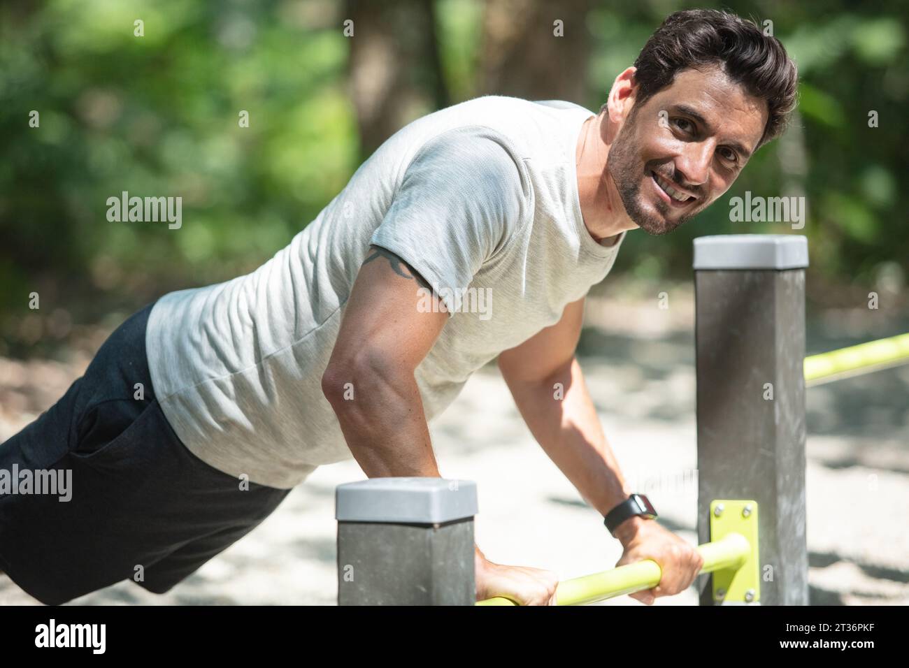 strong sporty man doing press exercises holding plank outdoors Stock ...