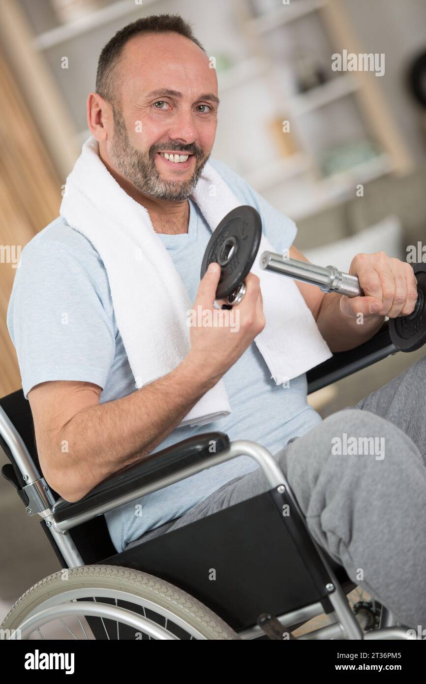 handsome disabled paraplegic man in wheelchair doing rehabilitation ...