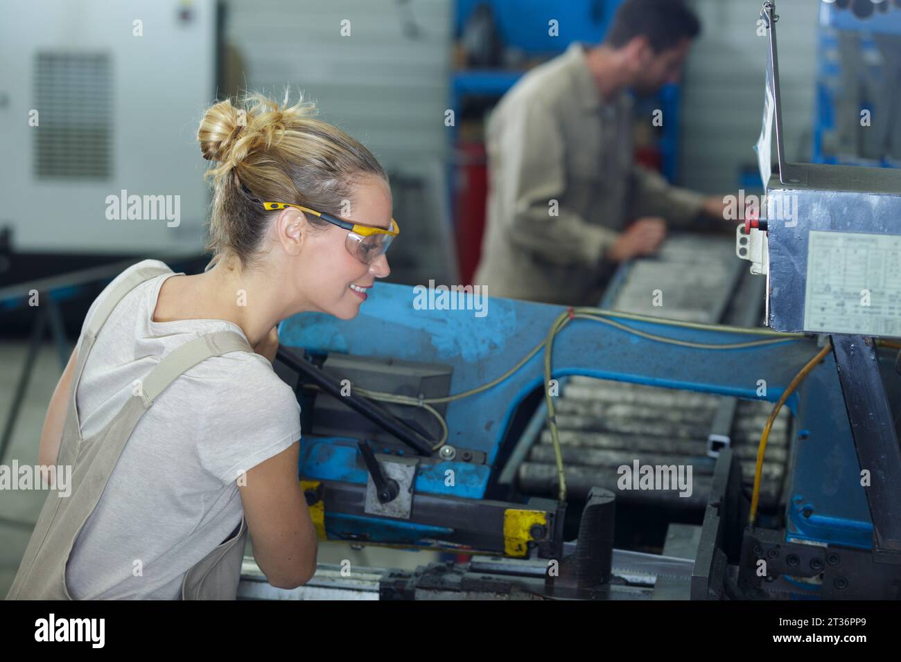 a pretty young machine operator at work Stock Photo - Alamy