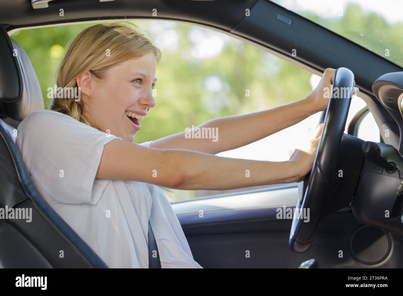 woman driving car with hand on horn button Stock Photo - Alamy