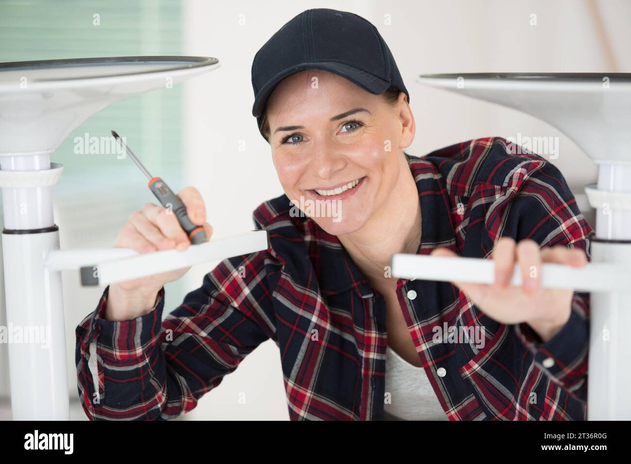 happy woman fixing a chair Stock Photo - Alamy