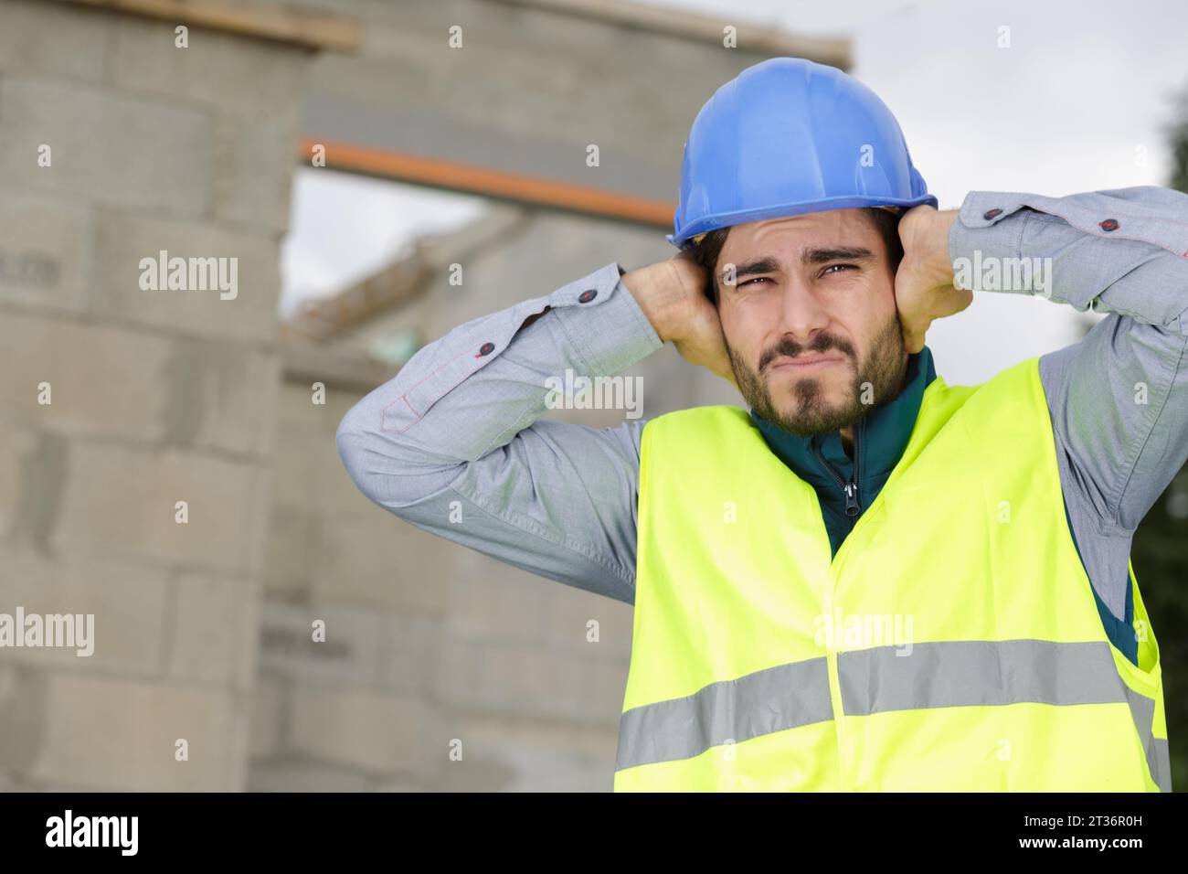 construction worker covering ears to ignore annoying loud noise Stock ...