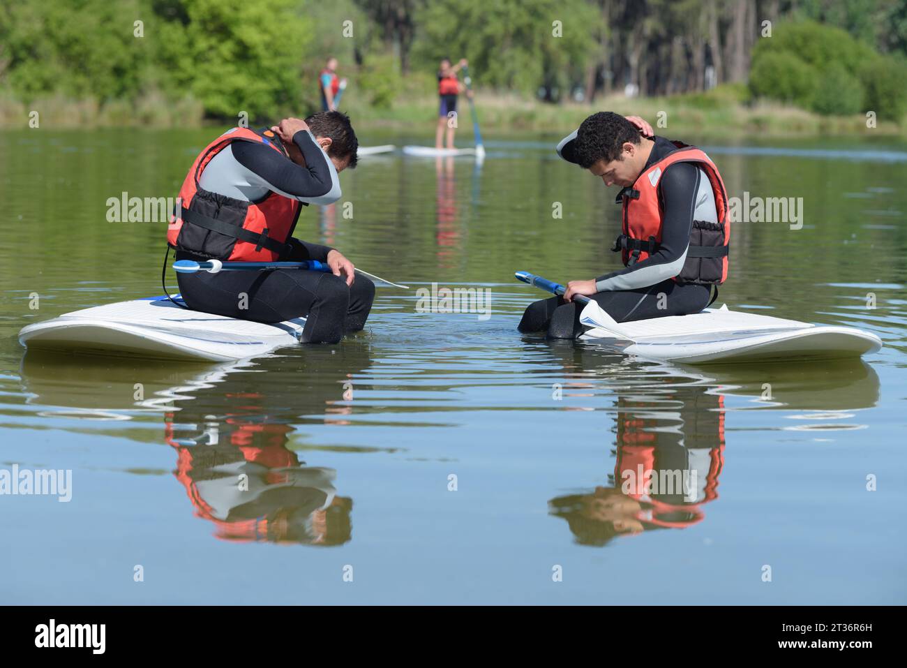 doing exercises before paddle boarding Stock Photo - Alamy