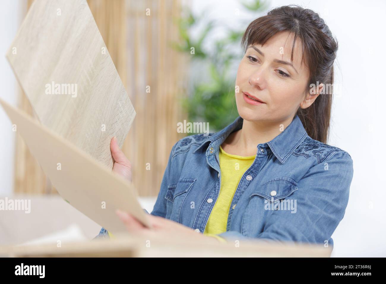 woman checks the angle of wood boards in a workshop Stock Photo - Alamy