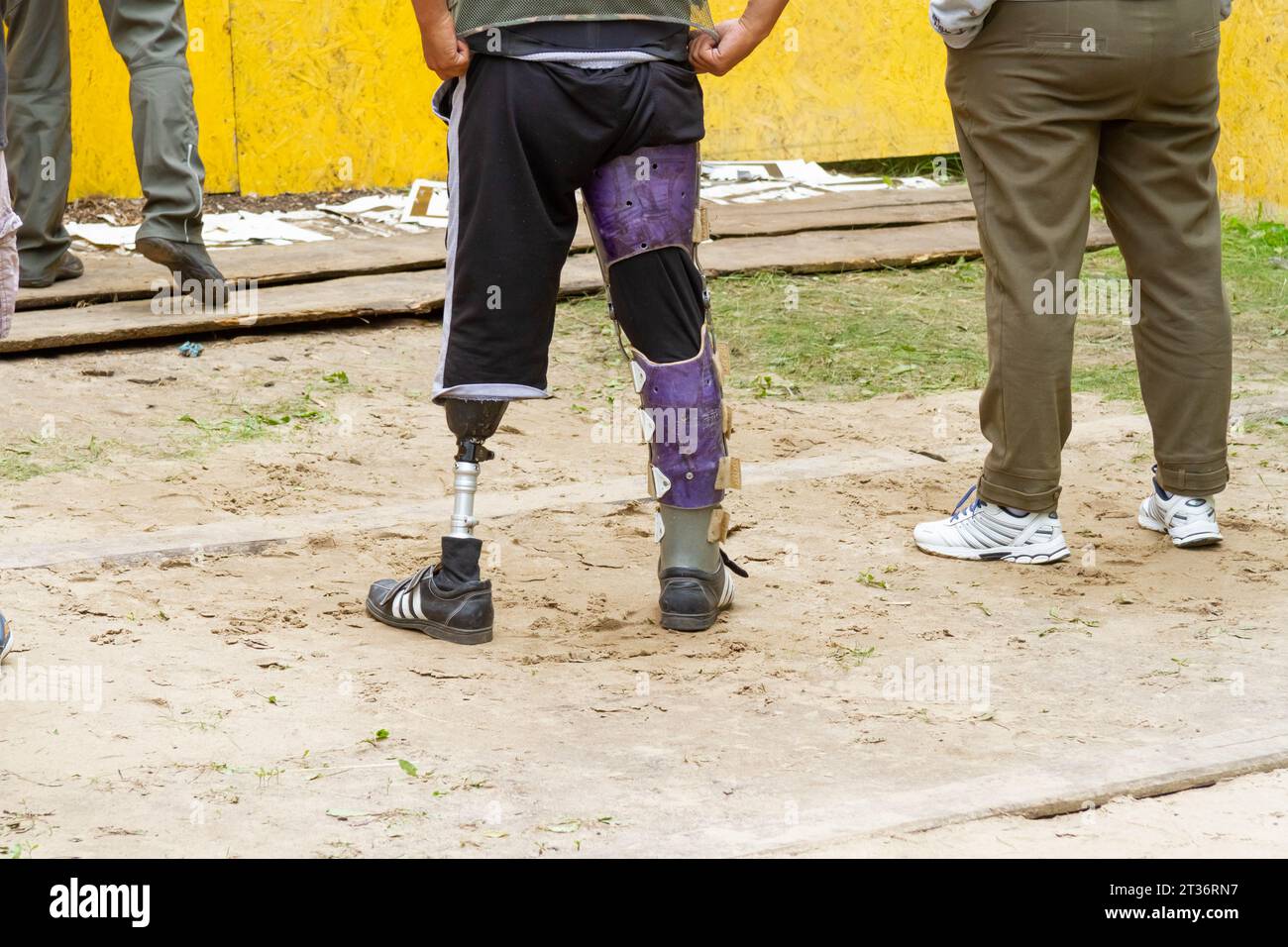 Sports and people with disabilities. A man without a leg throws knives ...