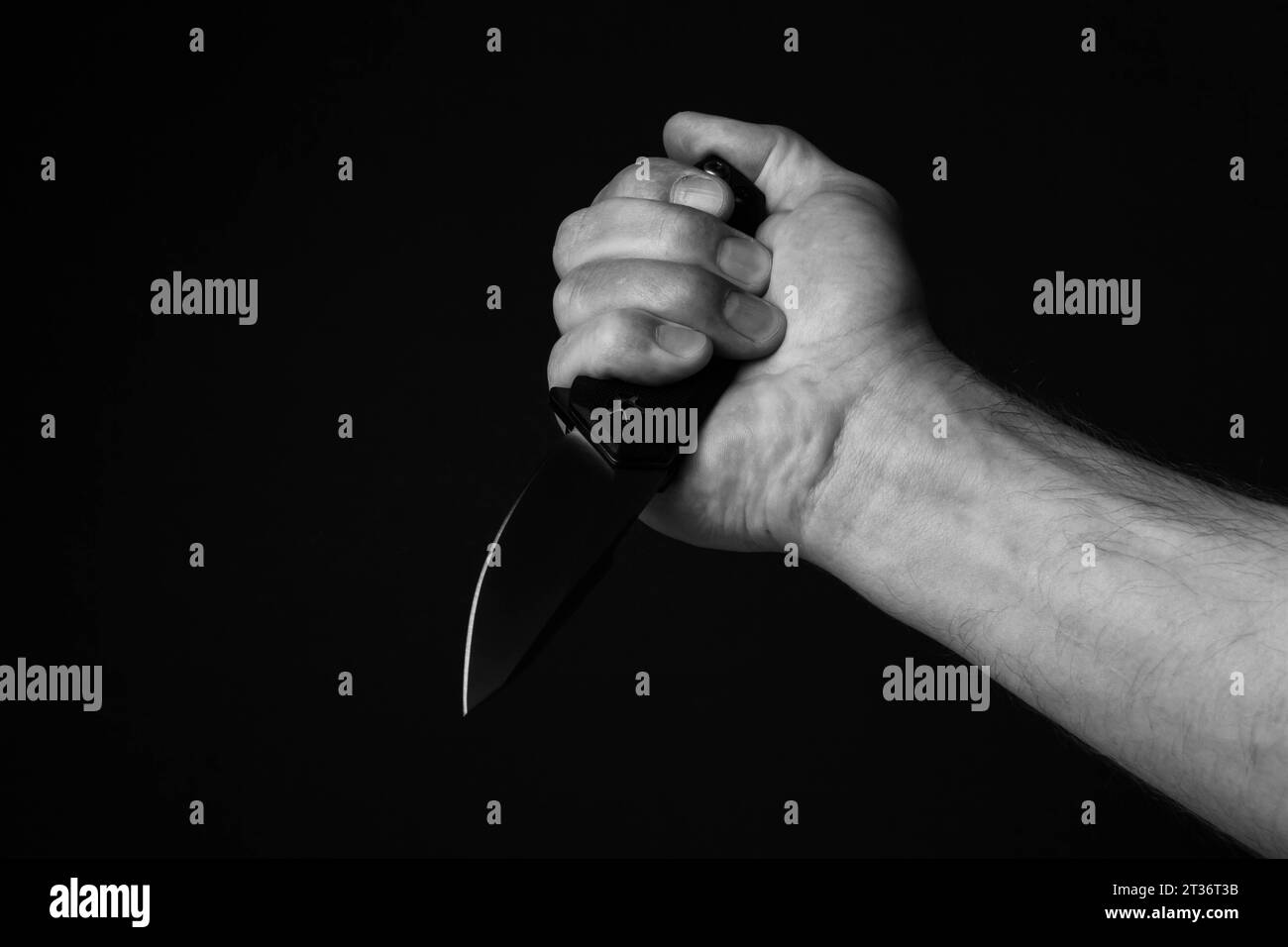 A sharp knife in the man's hand. The use of cold weapons. Knife attack ...