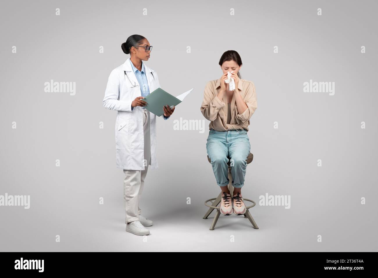 Serious black woman doctor and lady patient cry in clinic office ...
