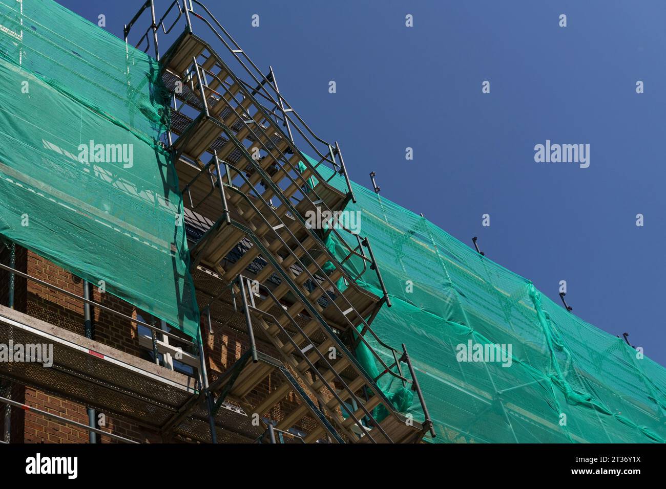 Scaffolding for renovation of building facades, covered with protective ...