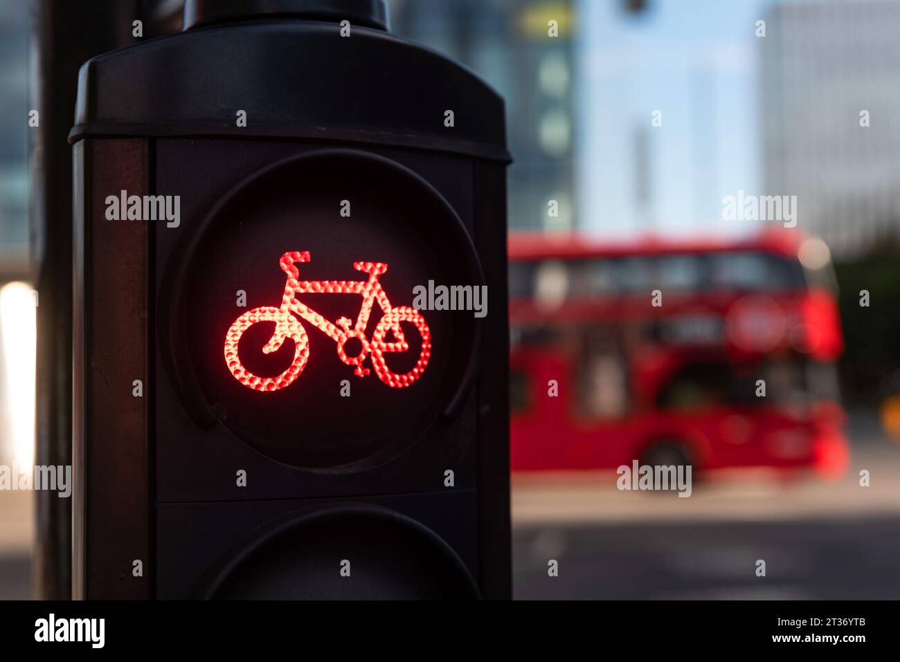 A red cycle lane traffic stop signal at a junction in a busy London ...