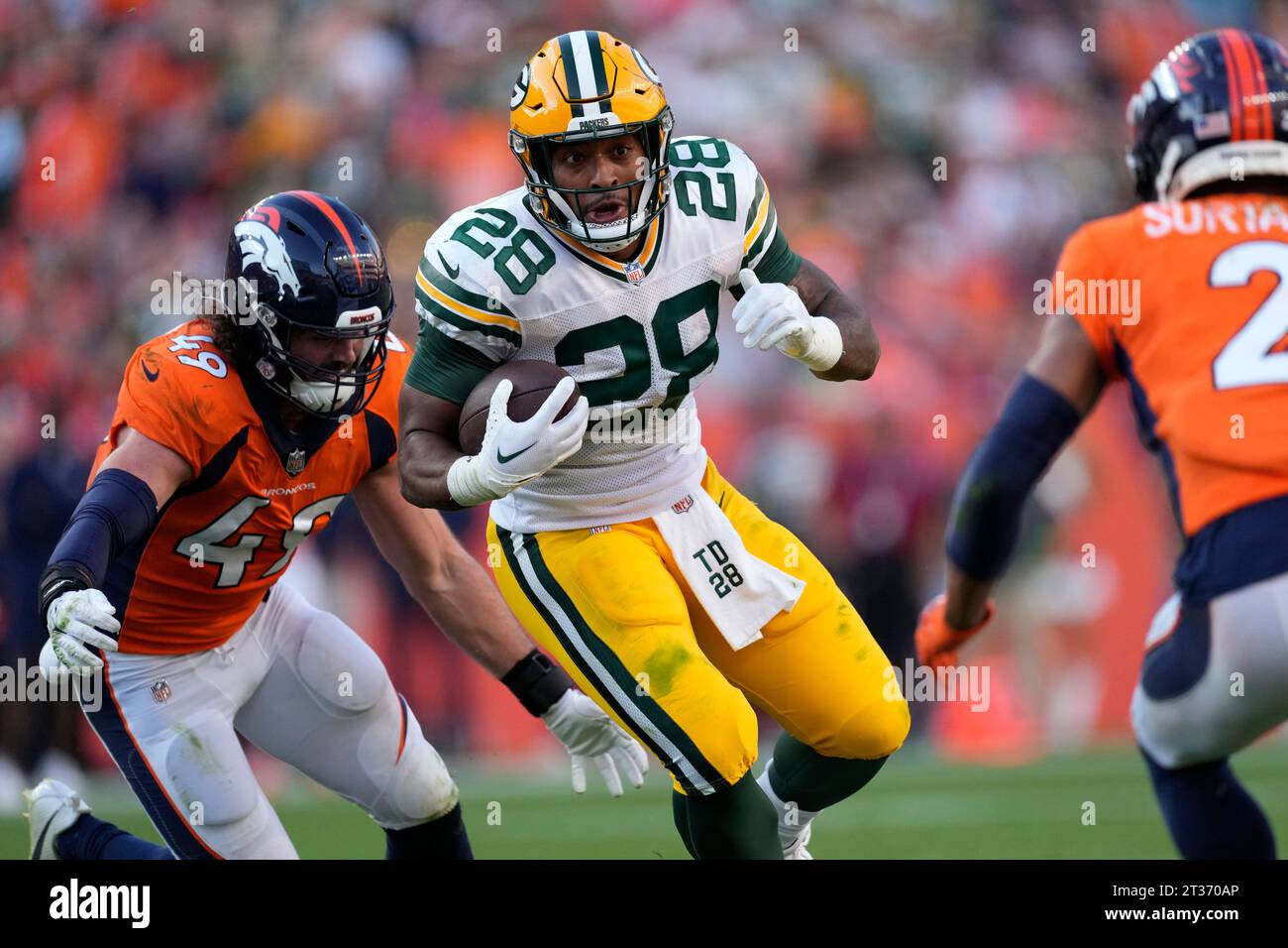 Green Bay Packers running back AJ Dillon (28) is pursued by Denver ...