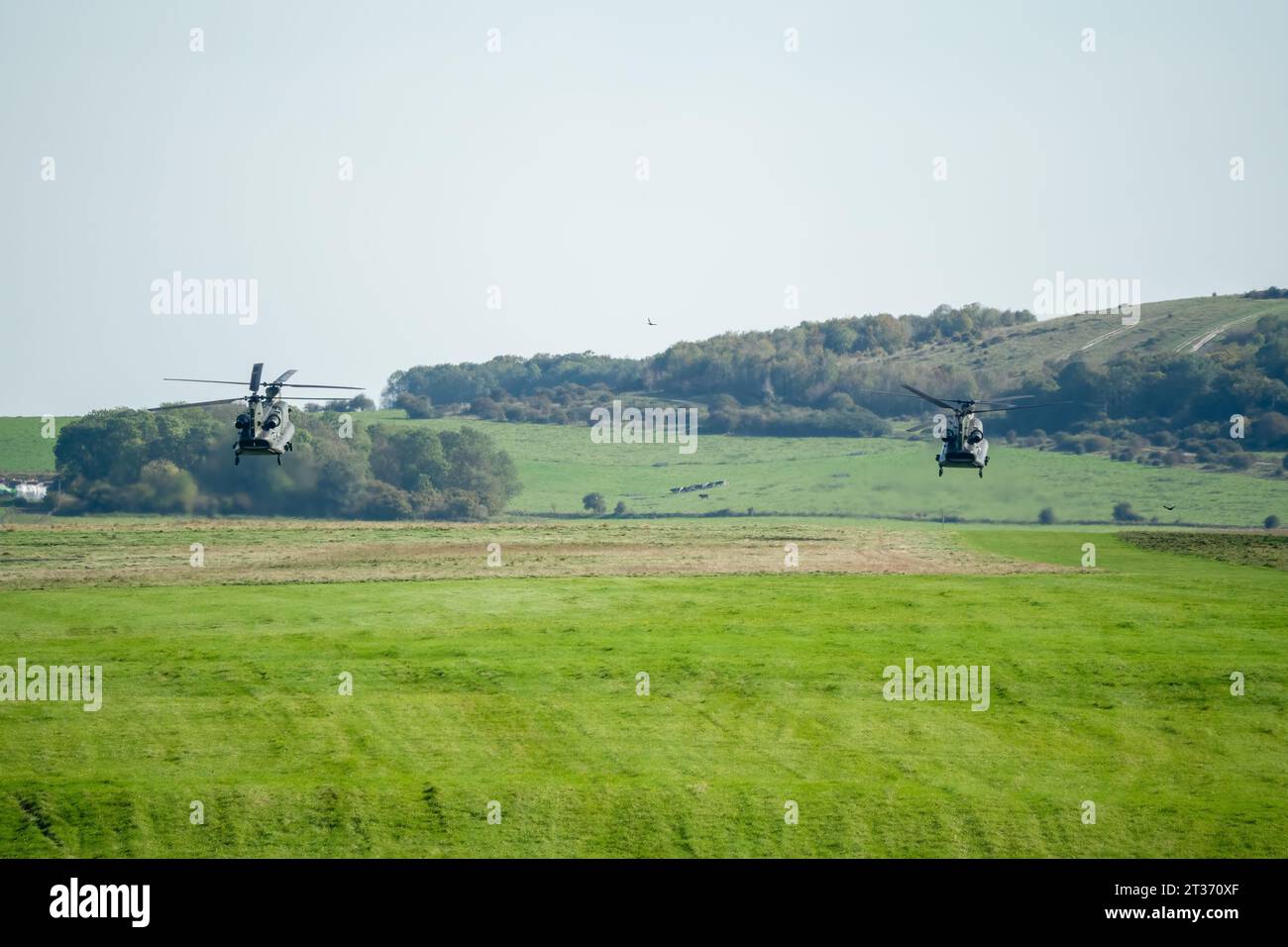 A pair of RAF Chinook tandem-rotor CH-47 helicopters transitioning to ...