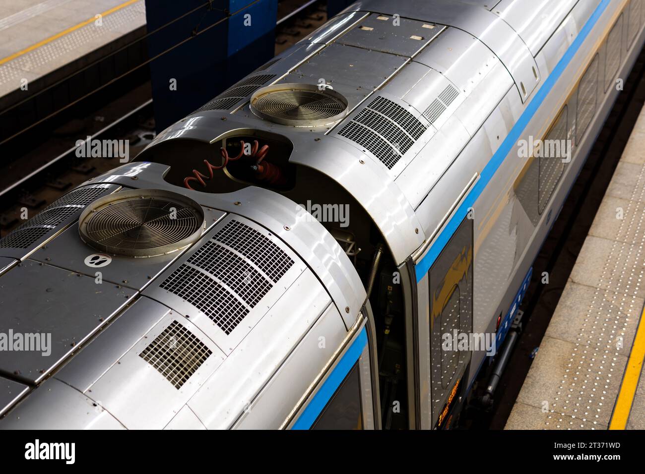 Passenger train carriages on the railway station platform seen from ...
