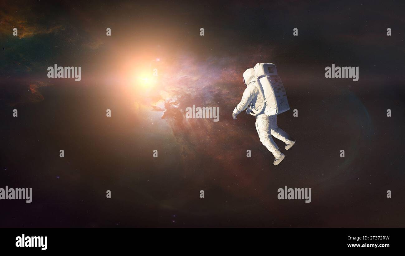 Cosmonaut floating in deep space on nebula background. Elements of this ...