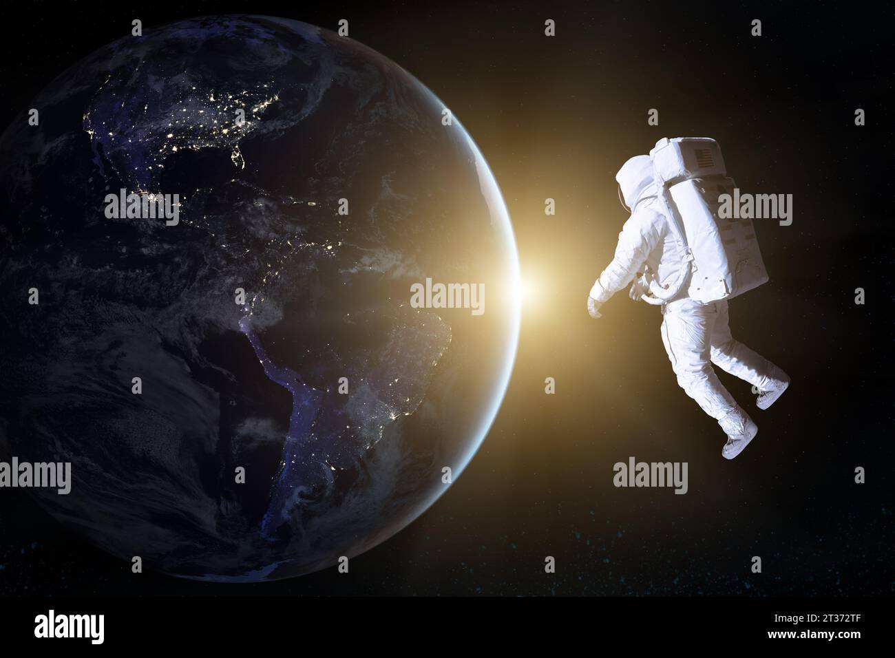 Astronaut in deep space looks on night Earth planet. Elements of this ...