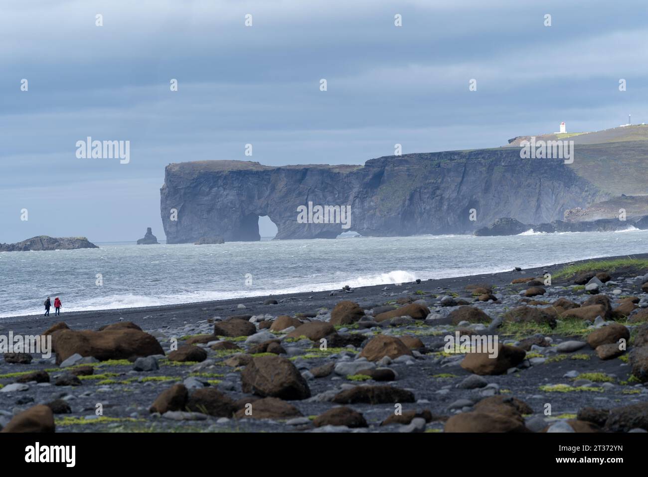 Black sand beach looking toward sea stacks and arches, in Vik, Iceland ...