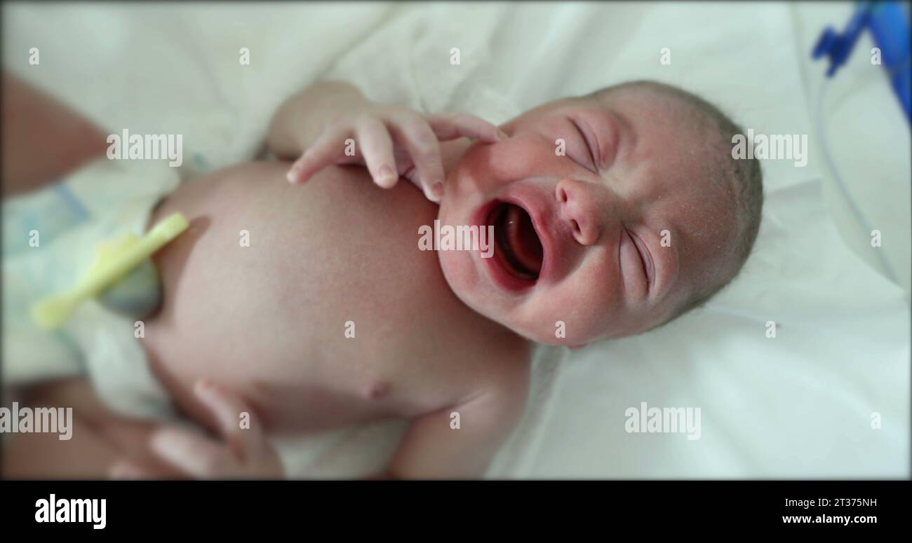 Newborn baby crying first minutes of life Stock Photo - Alamy