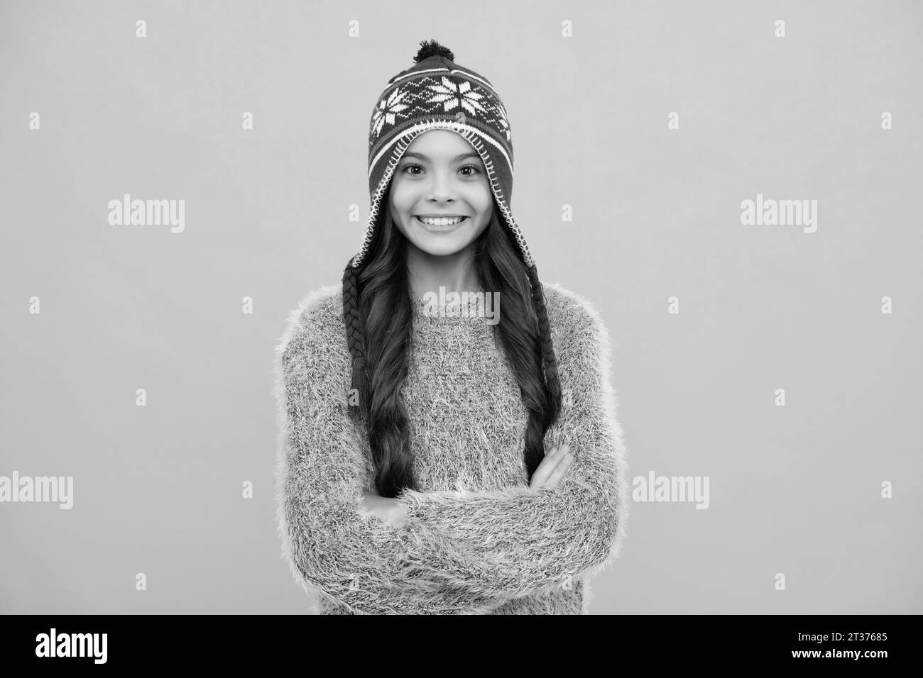 Beautiful teen girl in a winter hat and a warm sweater. A child on a ...