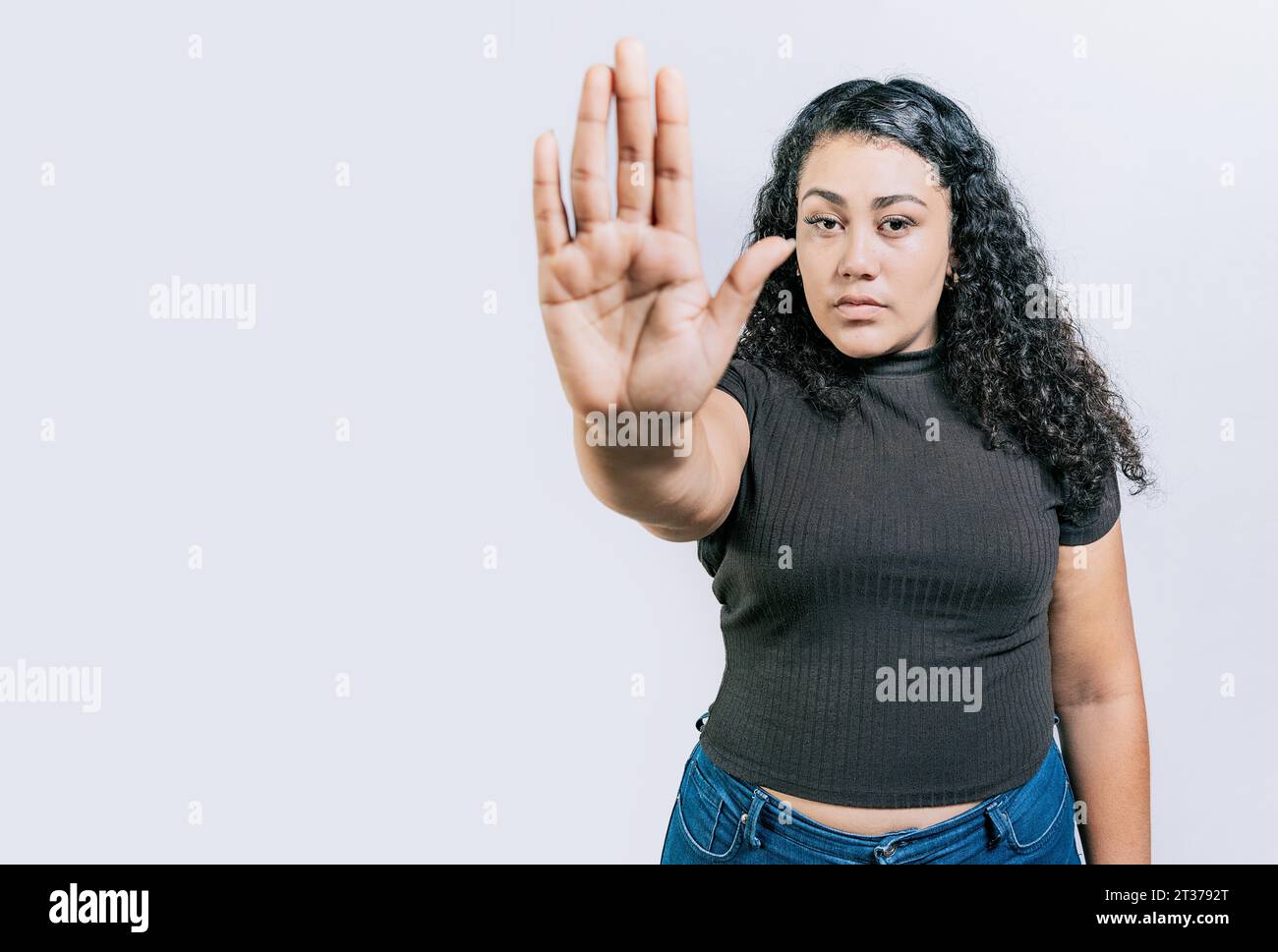 Serious woman rejecting with the palm of hand isolated. People ...