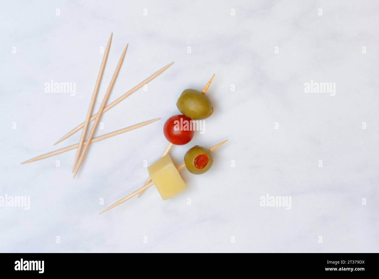 Stuffed olives on toothpicks, green olive Stock Photo - Alamy