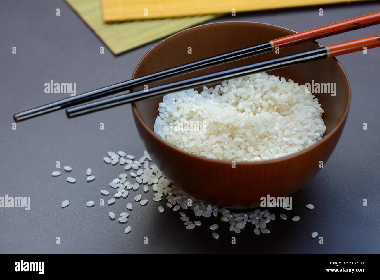 Rice, white rice in bowl with wooden ladle, uncooked Stock Photo - Alamy