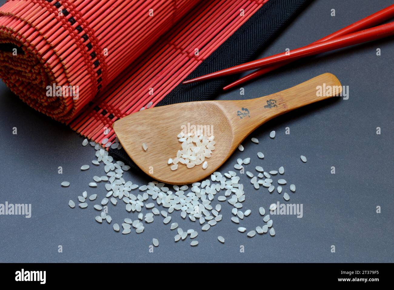 Rice, white rice grains and wooden ladle with bamboo mat Stock Photo ...