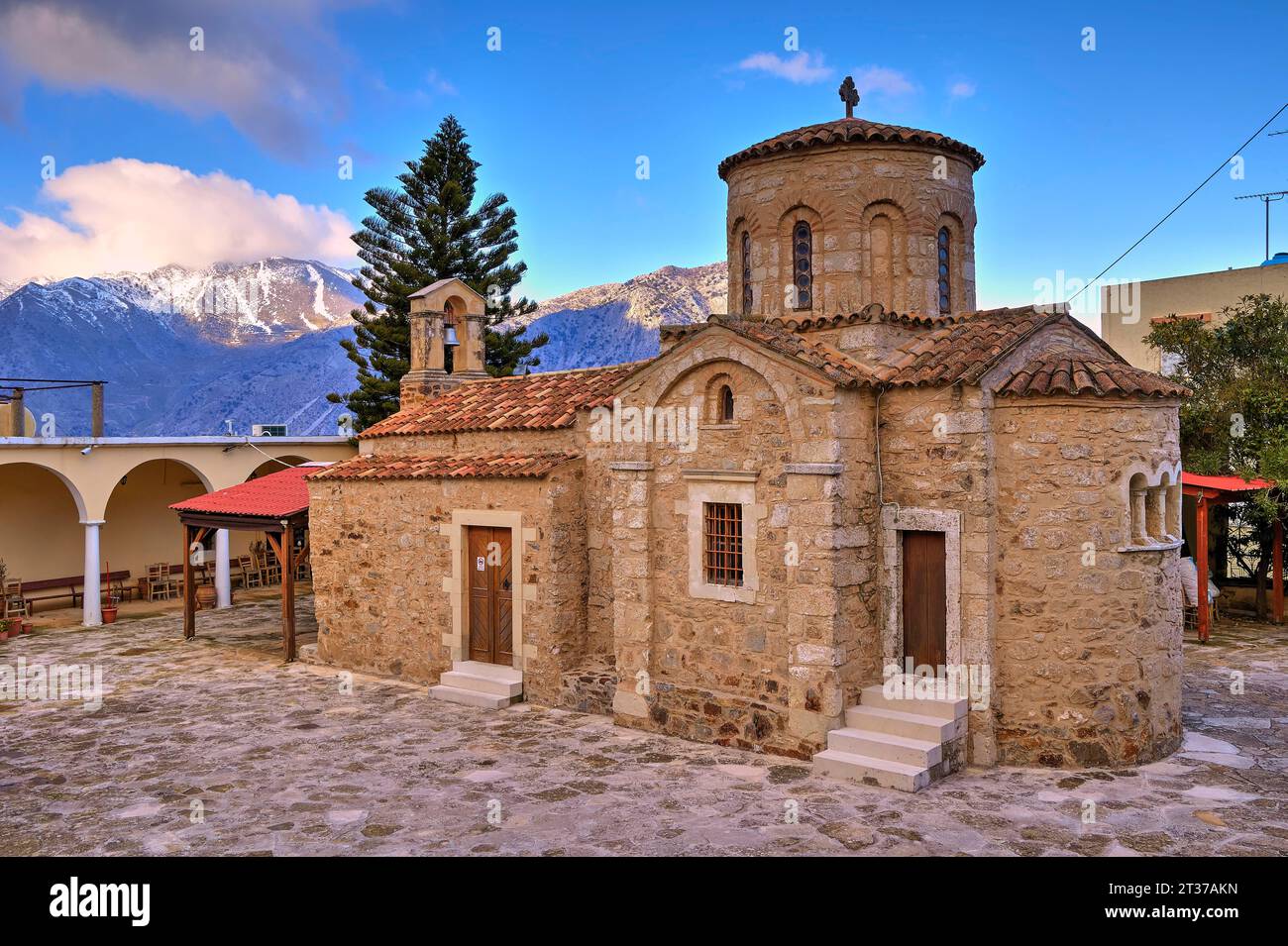 Byzantine church, dome, bell centre, tree, snow-capped mountains ...
