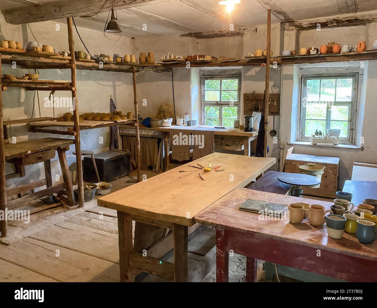 View into the workroom of a potter's workshop with pottery in the open ...