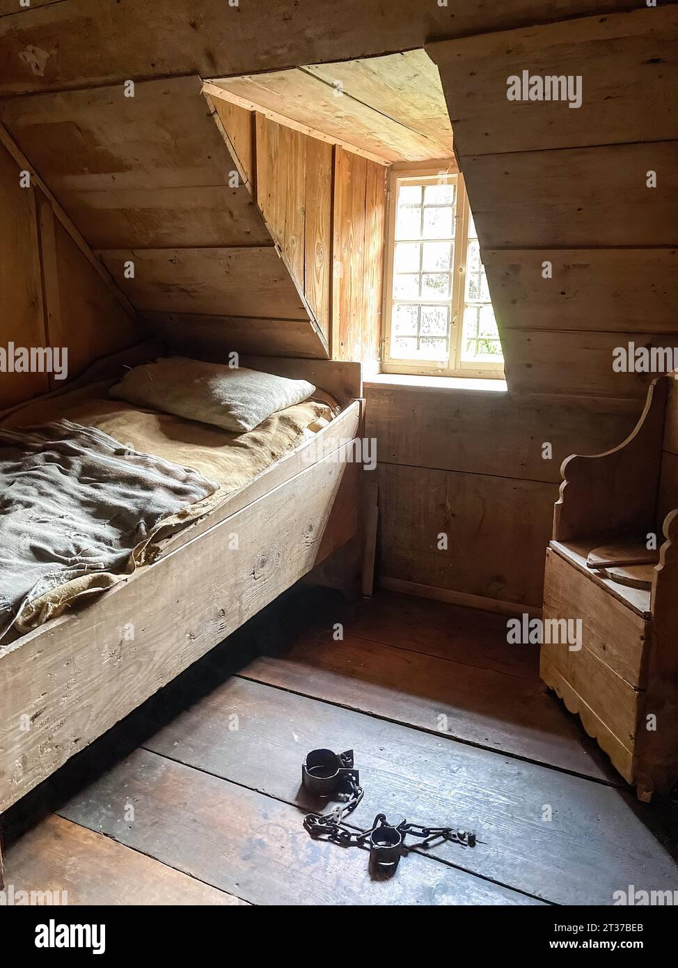Prison cell in historic rebuilt town hall with left bed with bed linen ...