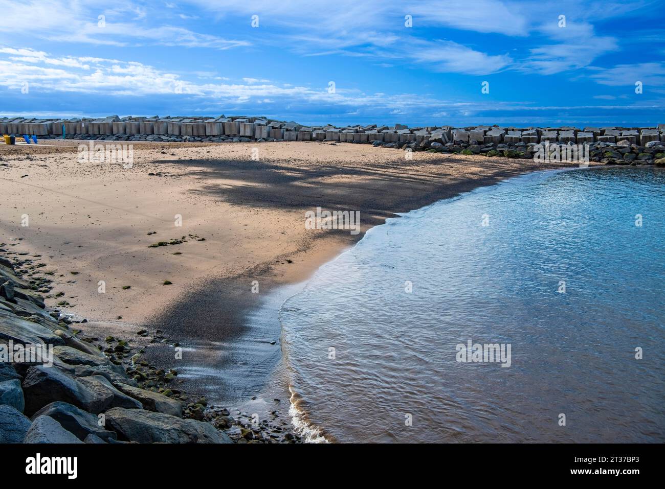 Artificially heaped up desolate sandy beach of Calheta, Madeira Island ...