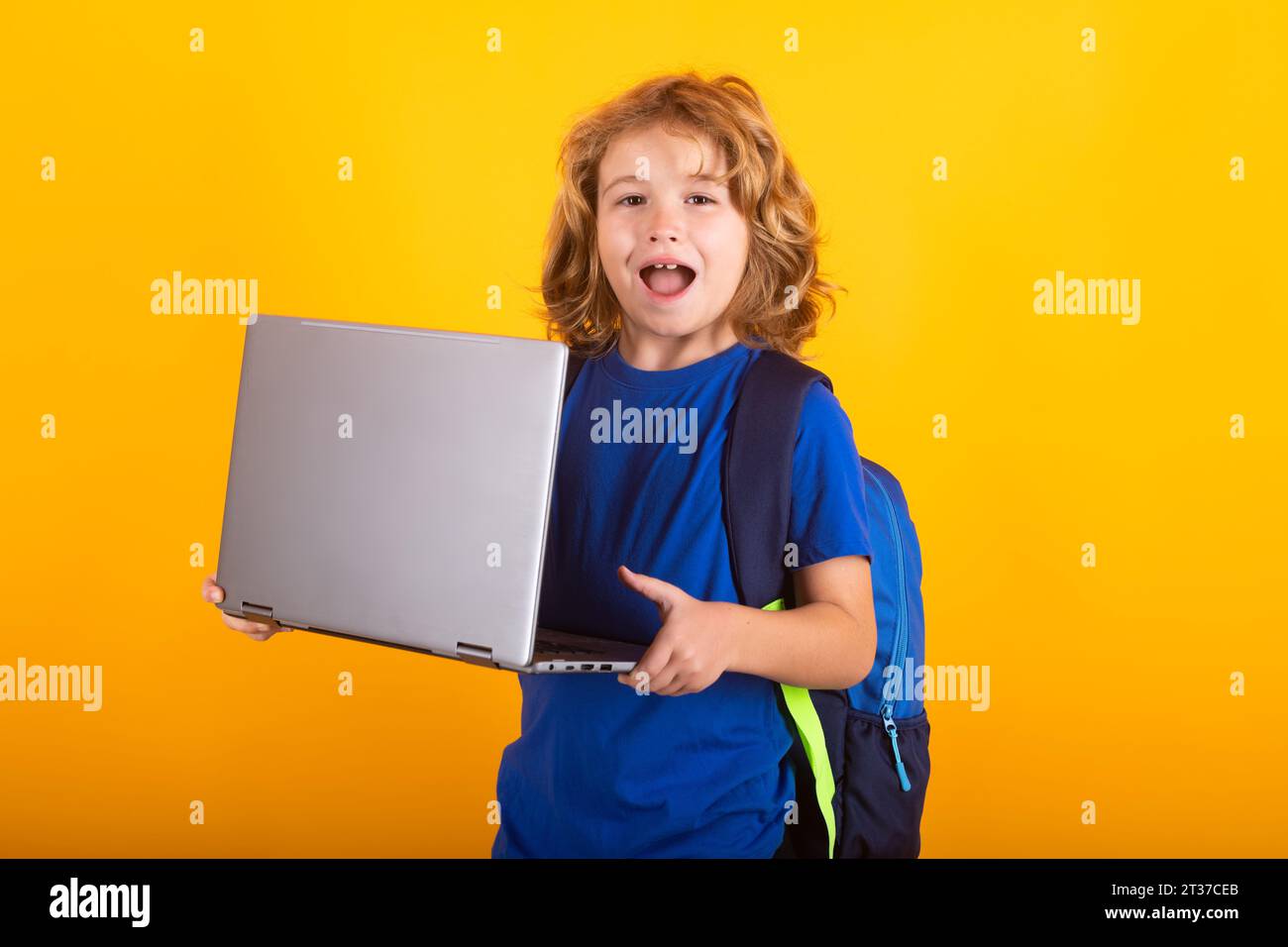 School child using laptop computer. Portrait of school boy isolated on ...