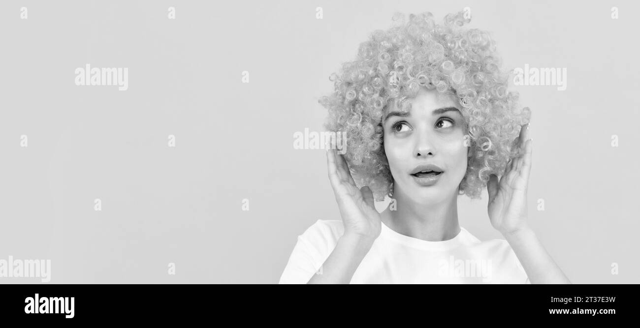 amazed fancy party look. freaky woman in clown wig on yellow background ...