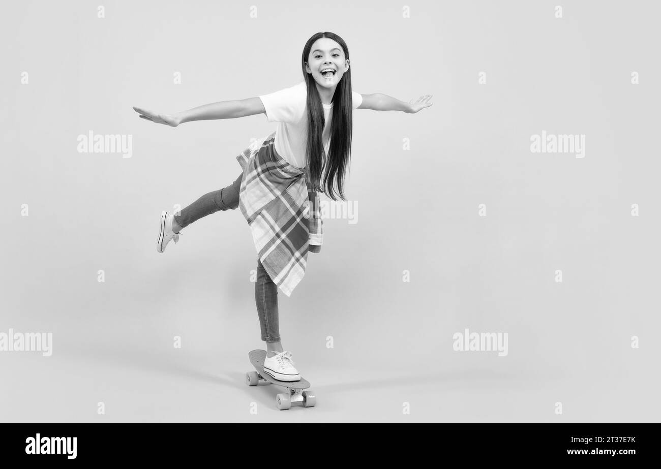 Teen hipster girl skater with skateboard on isolated background. Summer ...