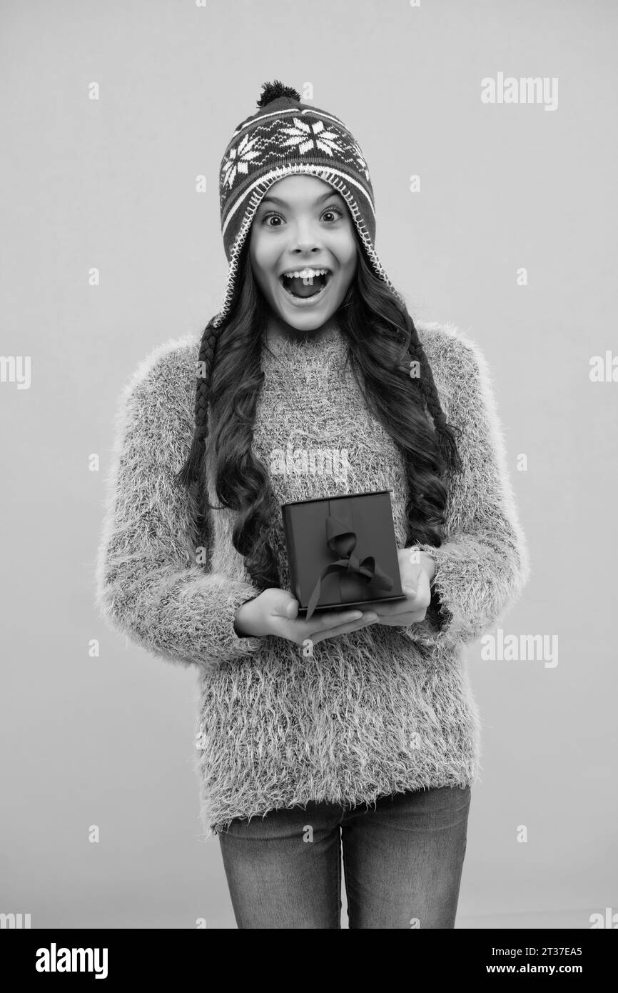 Emotional teenager child hold gift on birthday. Funny kid girl holding ...