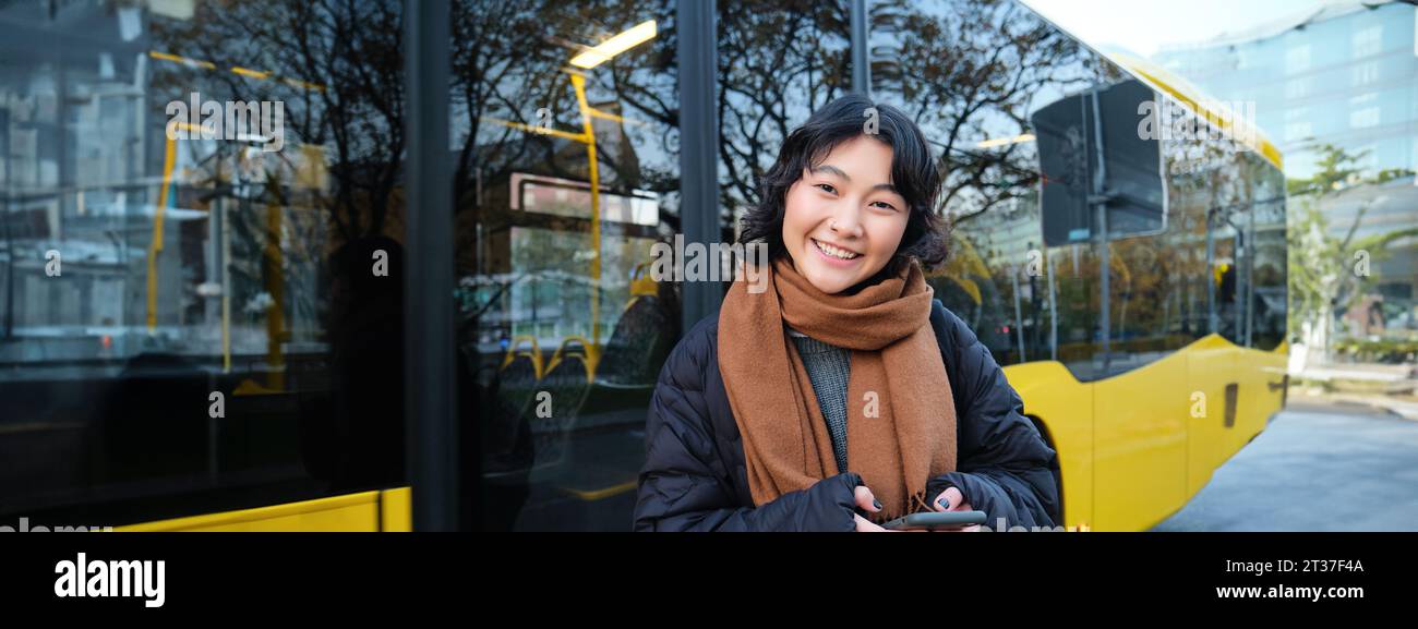 Portrait of korean girl buying ticket for public transport online ...