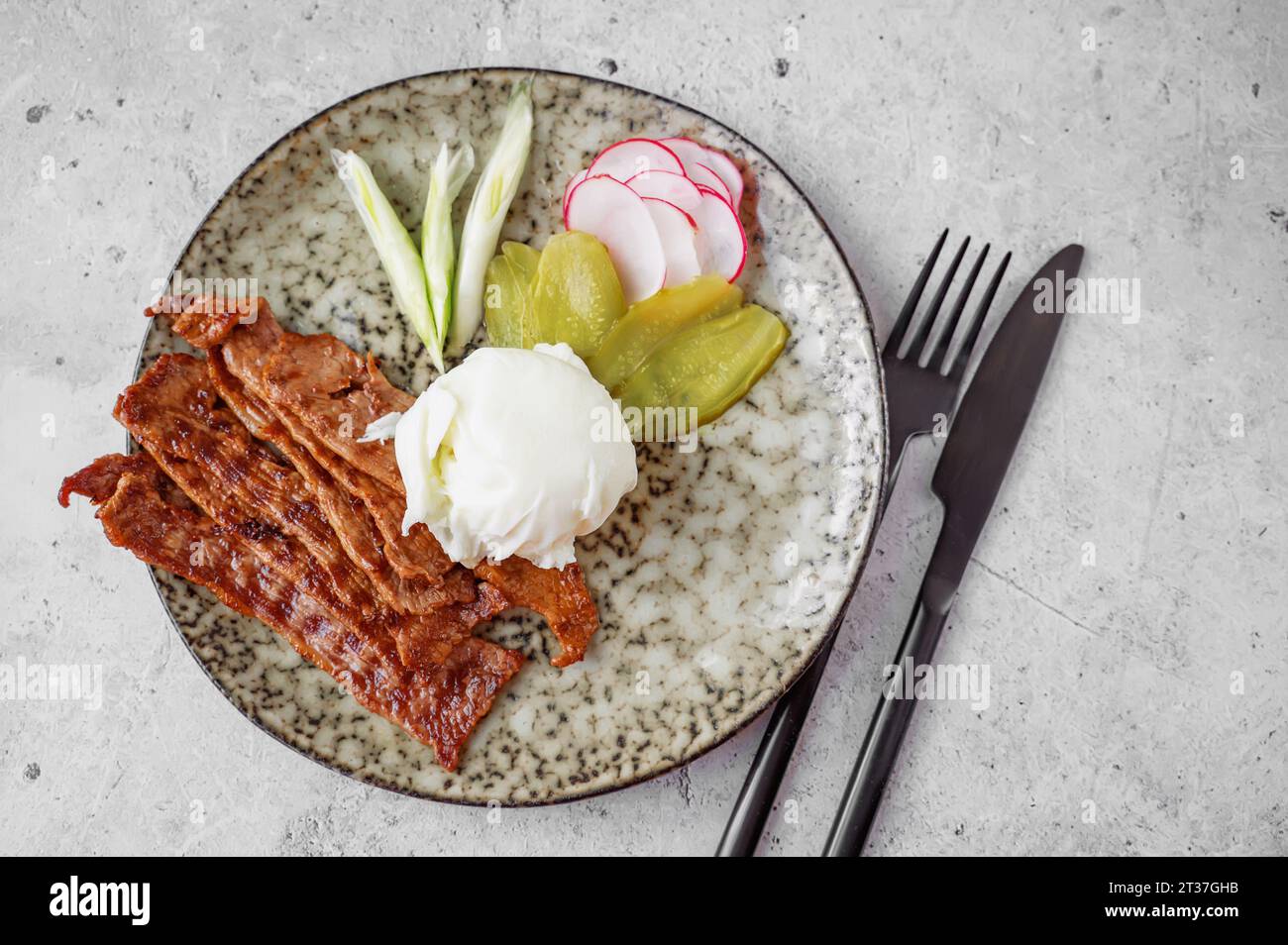 poached egg with beef bacon. Thin pieces of beef are grilled with eggs ...