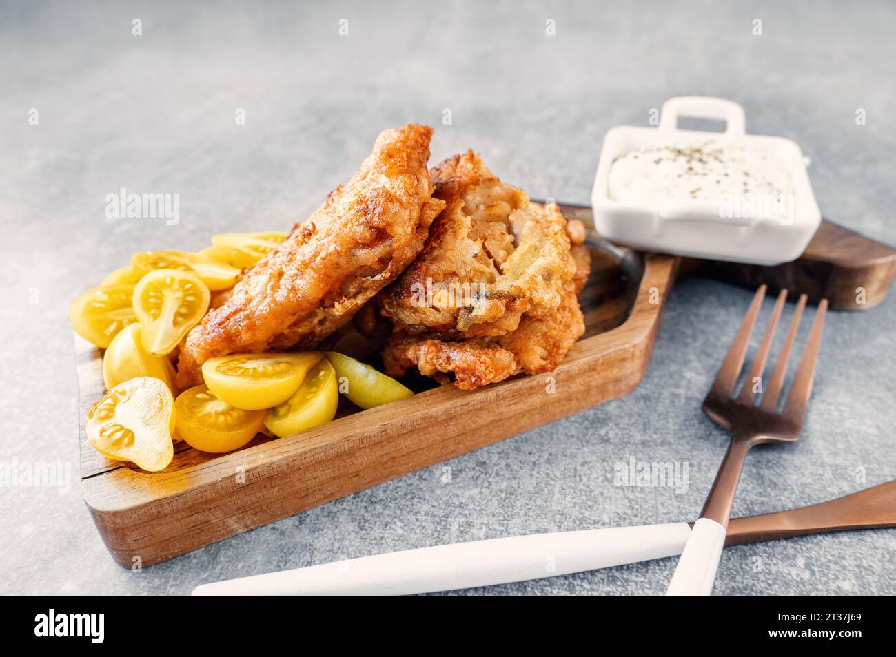 The fish dish is fried cod fillet with a creamy sauce and yellow plum ...