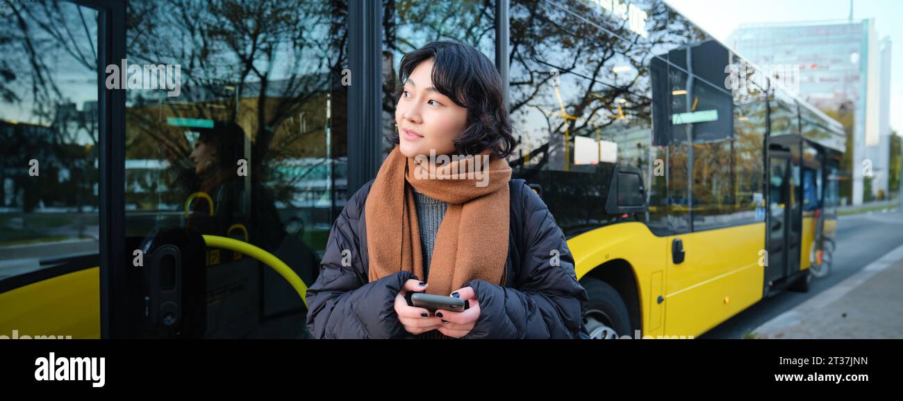 Portrait of korean girl buying ticket for public transport online ...