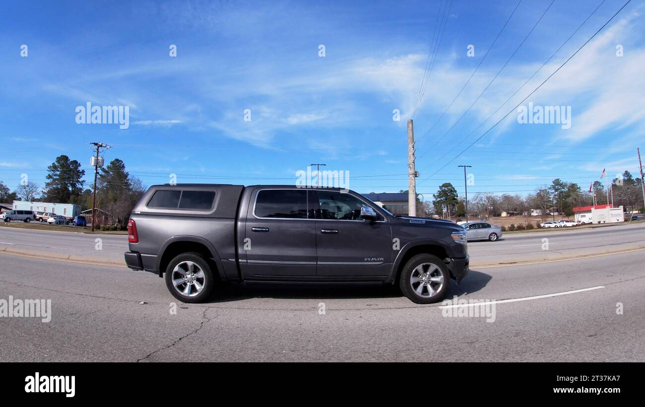 Augusta, Ga USA - 01 19 22: POV Driving street pan Dark color Dodge Ram ...
