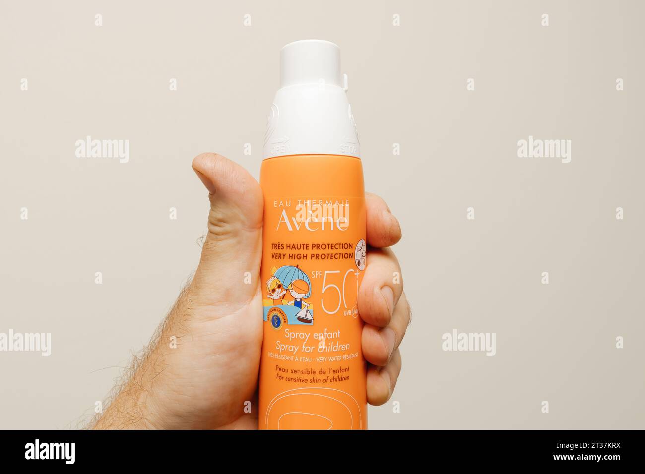 Paris, France - May 30, 2023: male hand showcases an orange sunscreen ...