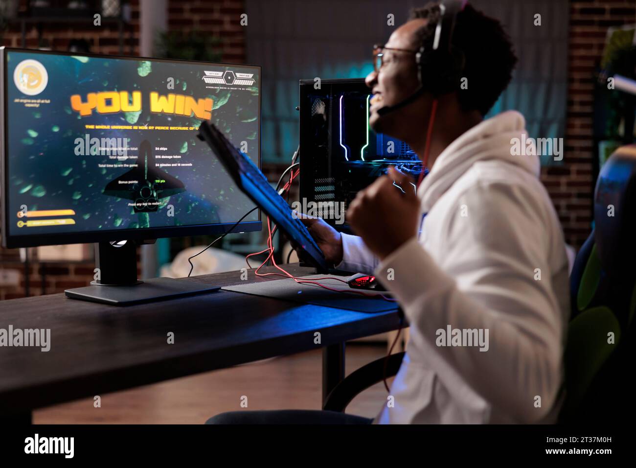 Gamer playing intense classic arcade spaceship racing videogame ...