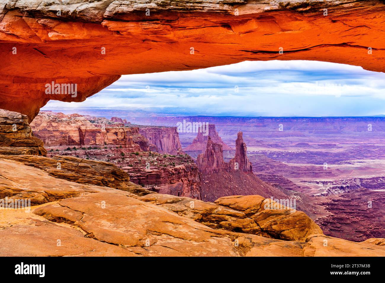 Mesa Arch with an incoming storm, view to canyon and washerwoman Arch ...