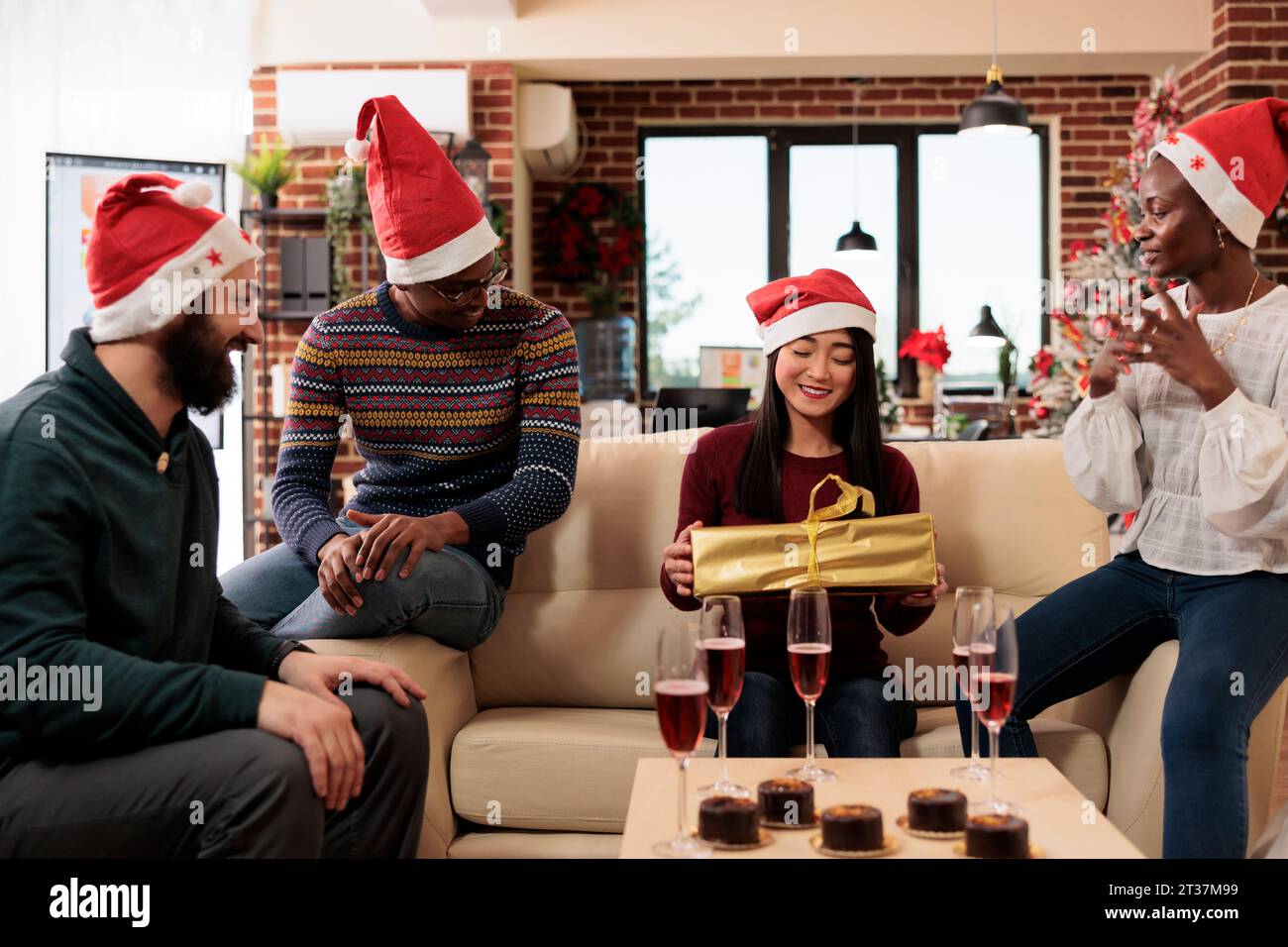 Smiling asian woman worker receiving present from coworkers while ...