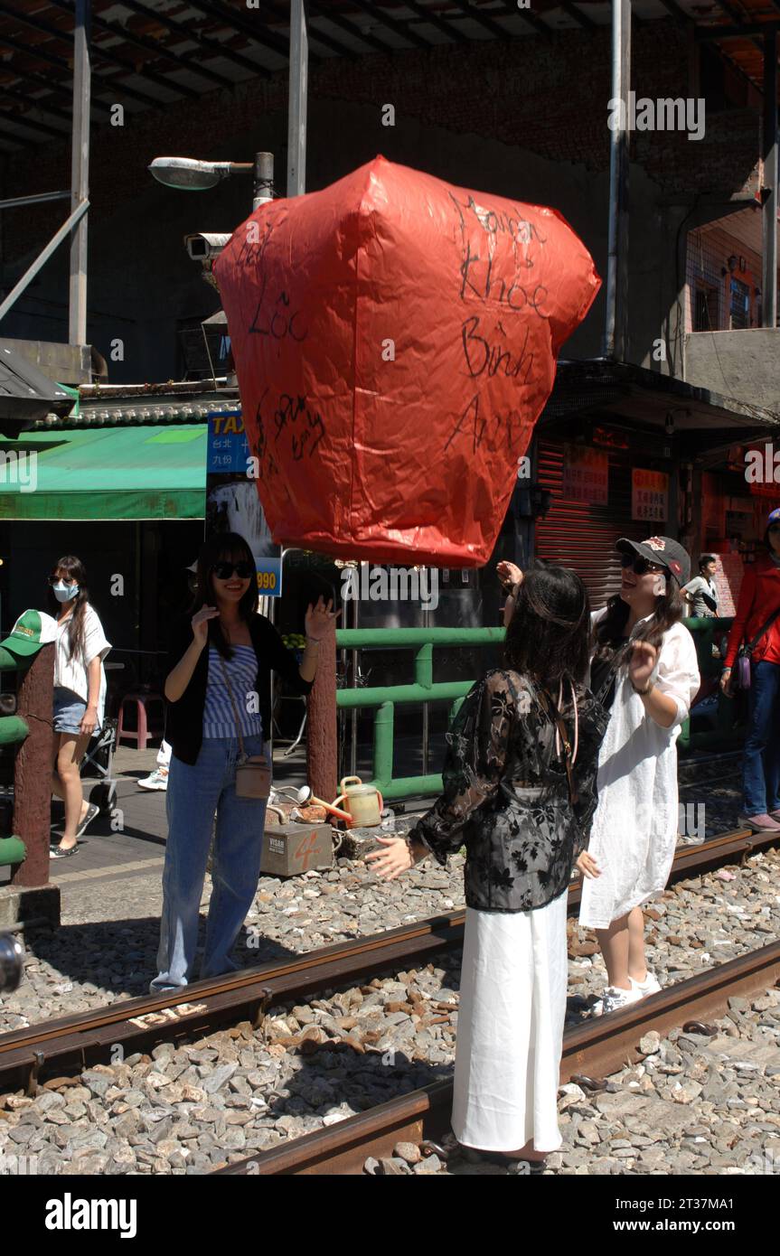 Tourists releasing lanterns into the sky, Shifen Old Street section of ...