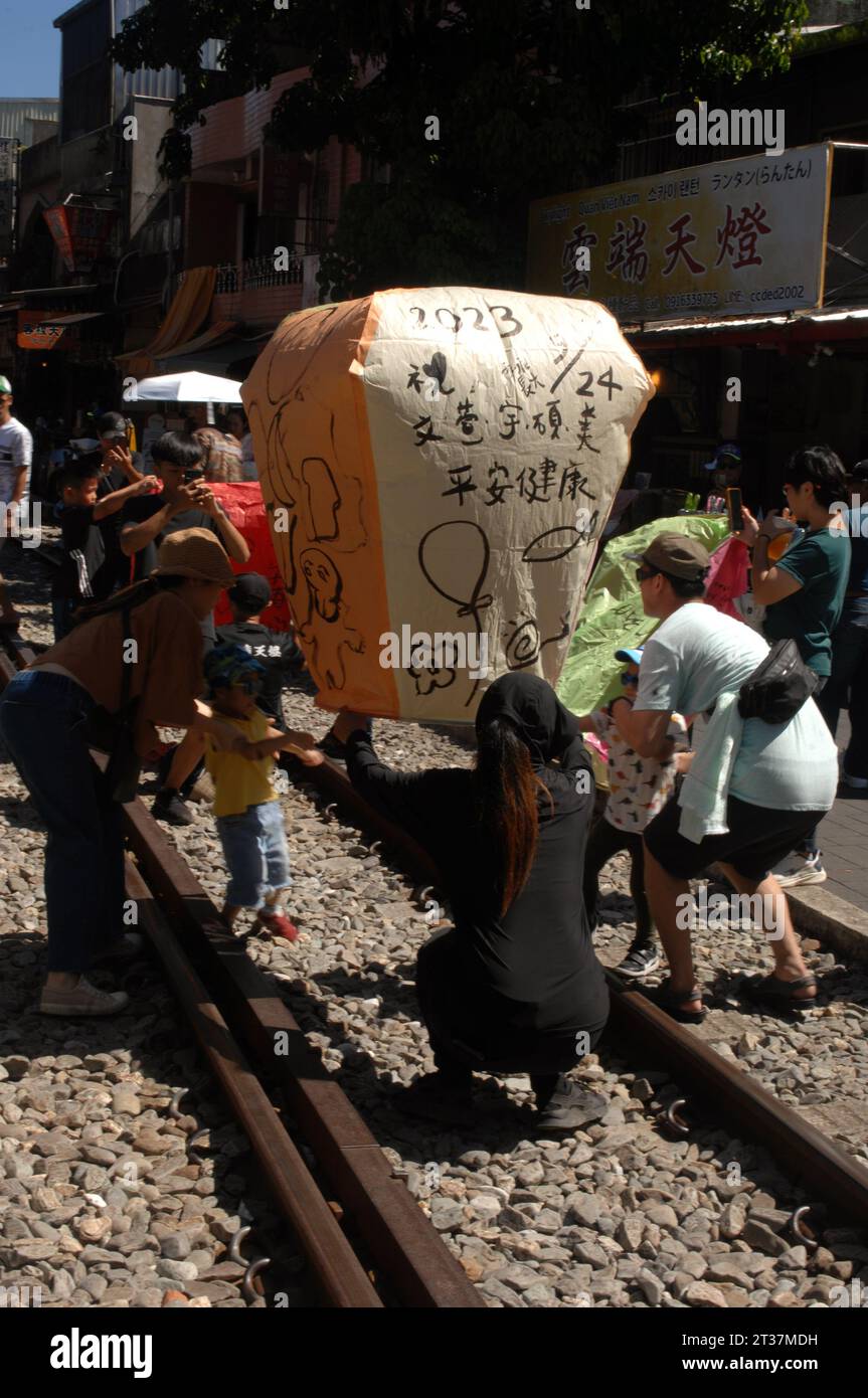 Tourists releasing lanterns into the sky, Shifen Old Street section of ...