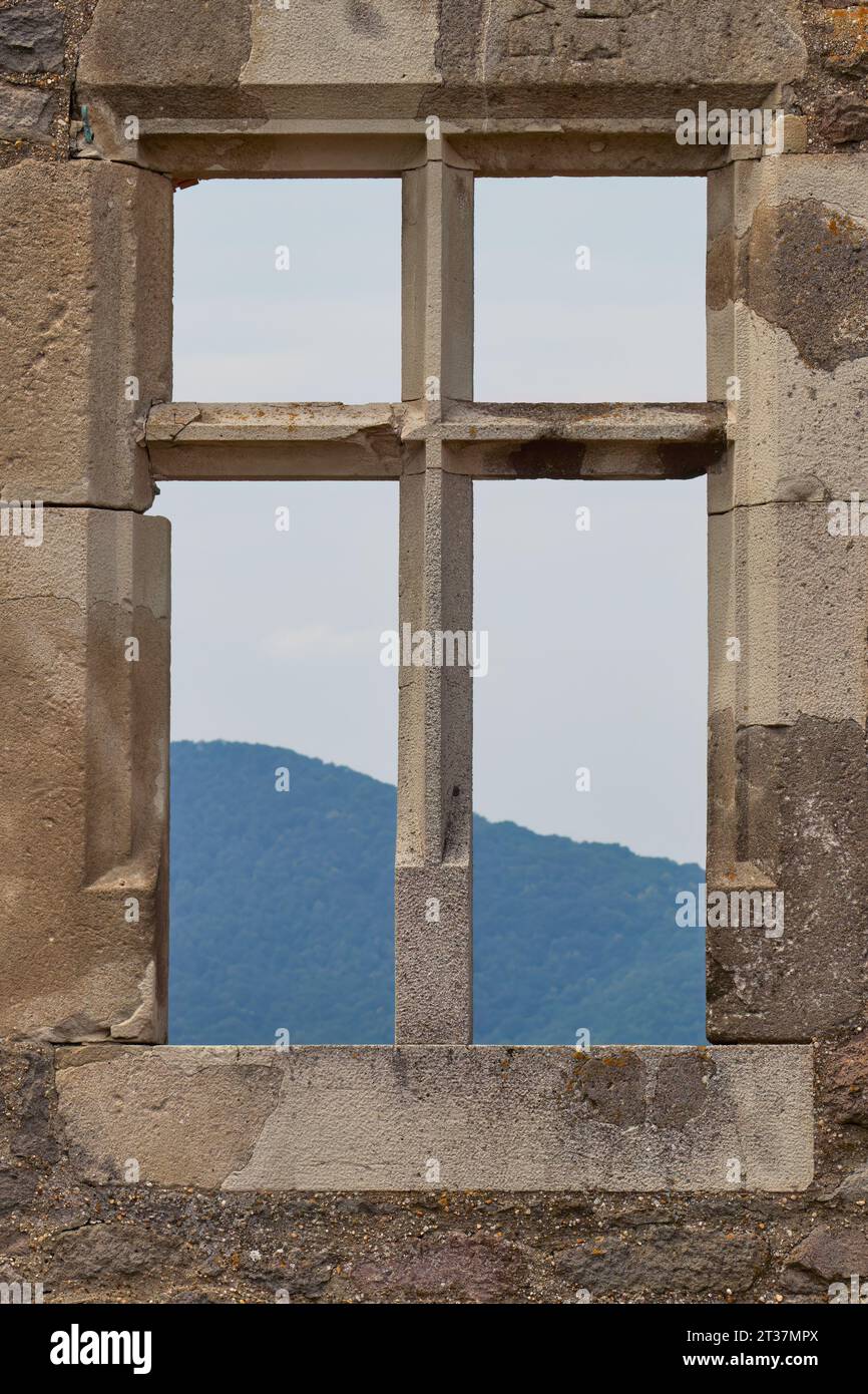 An outdoor stone window frame with a stunning mountain landscape view ...