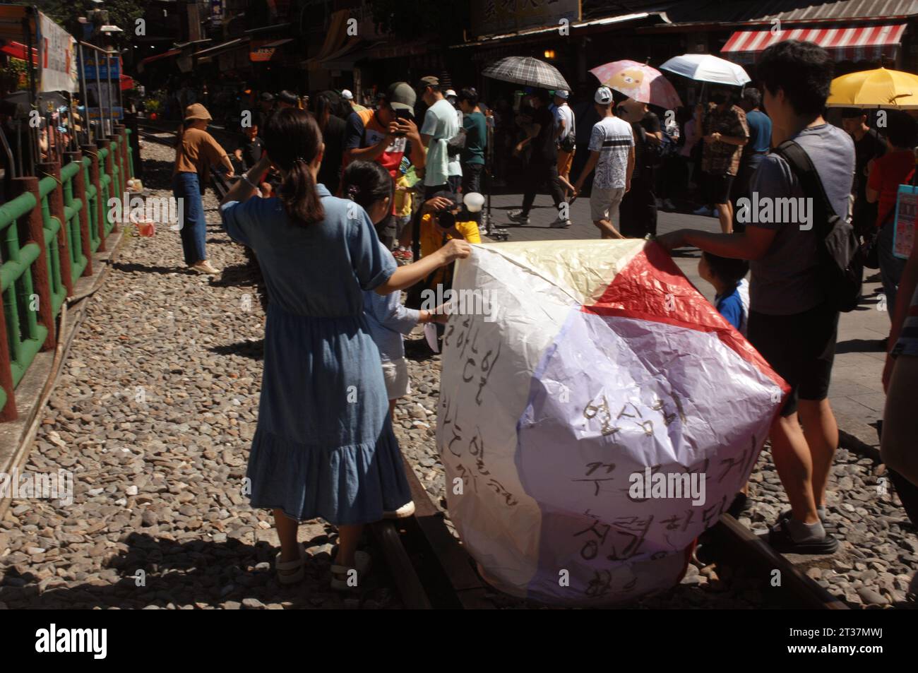 Tourists releasing lanterns into the sky, Shifen Old Street section of ...