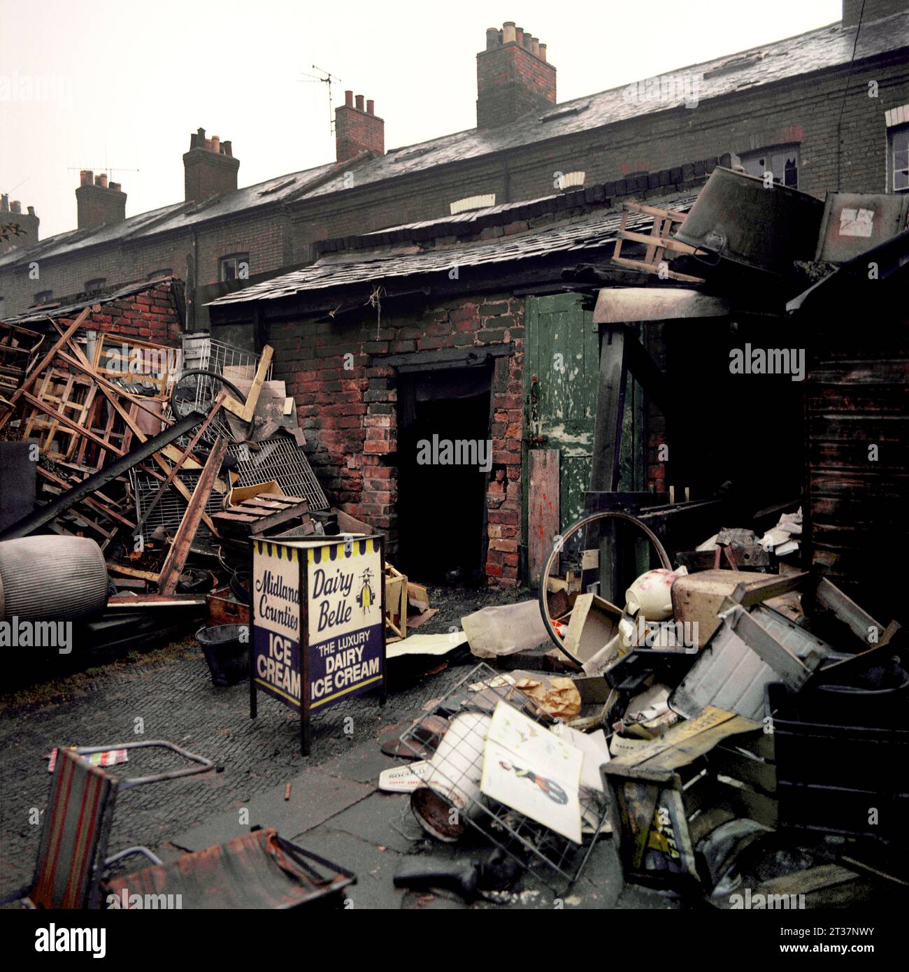Piles of discarded items such as wooden crates, wire trays, tin baths ...